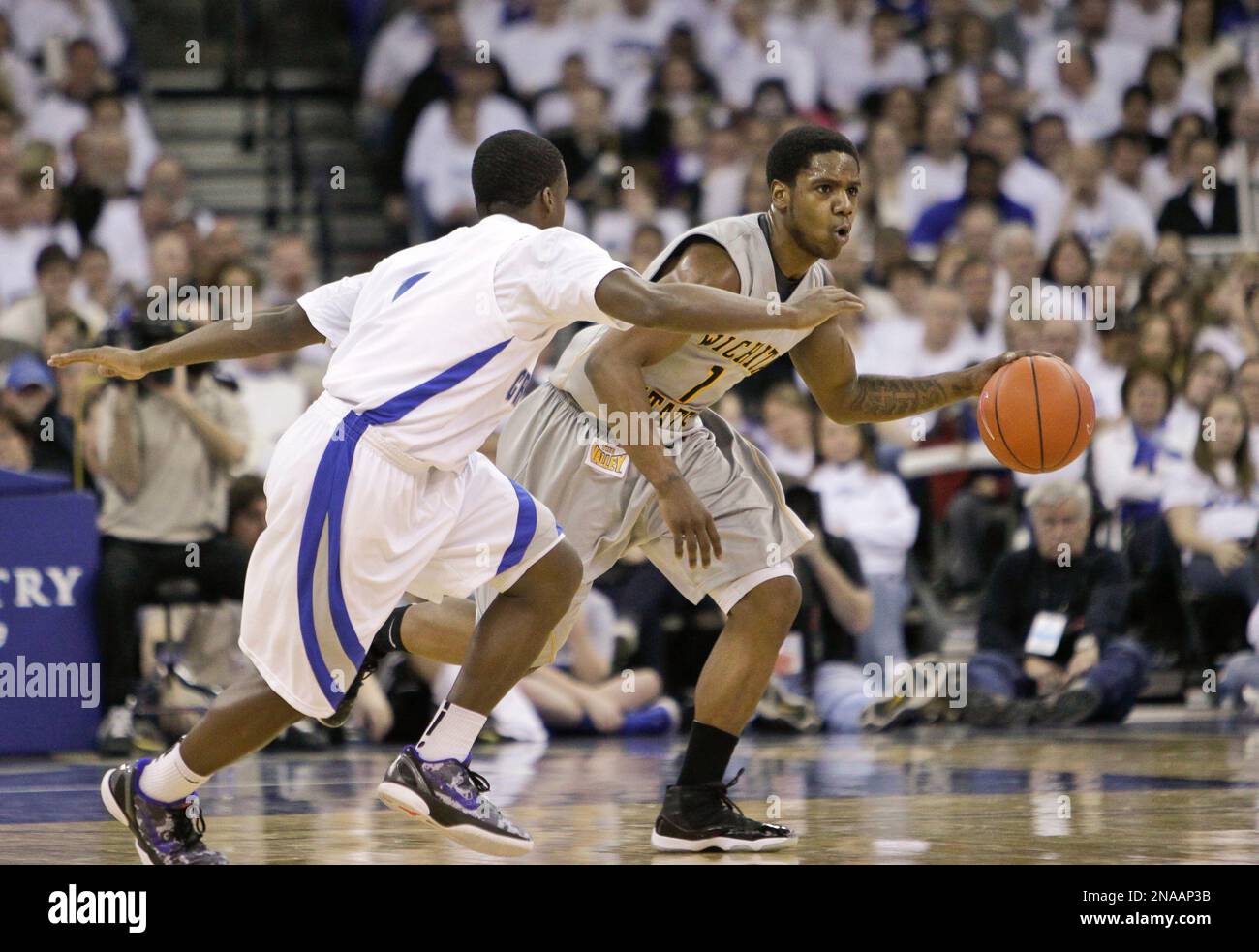 Wichita State's Joe Ragland, right, drives past Creighton's Austin ...