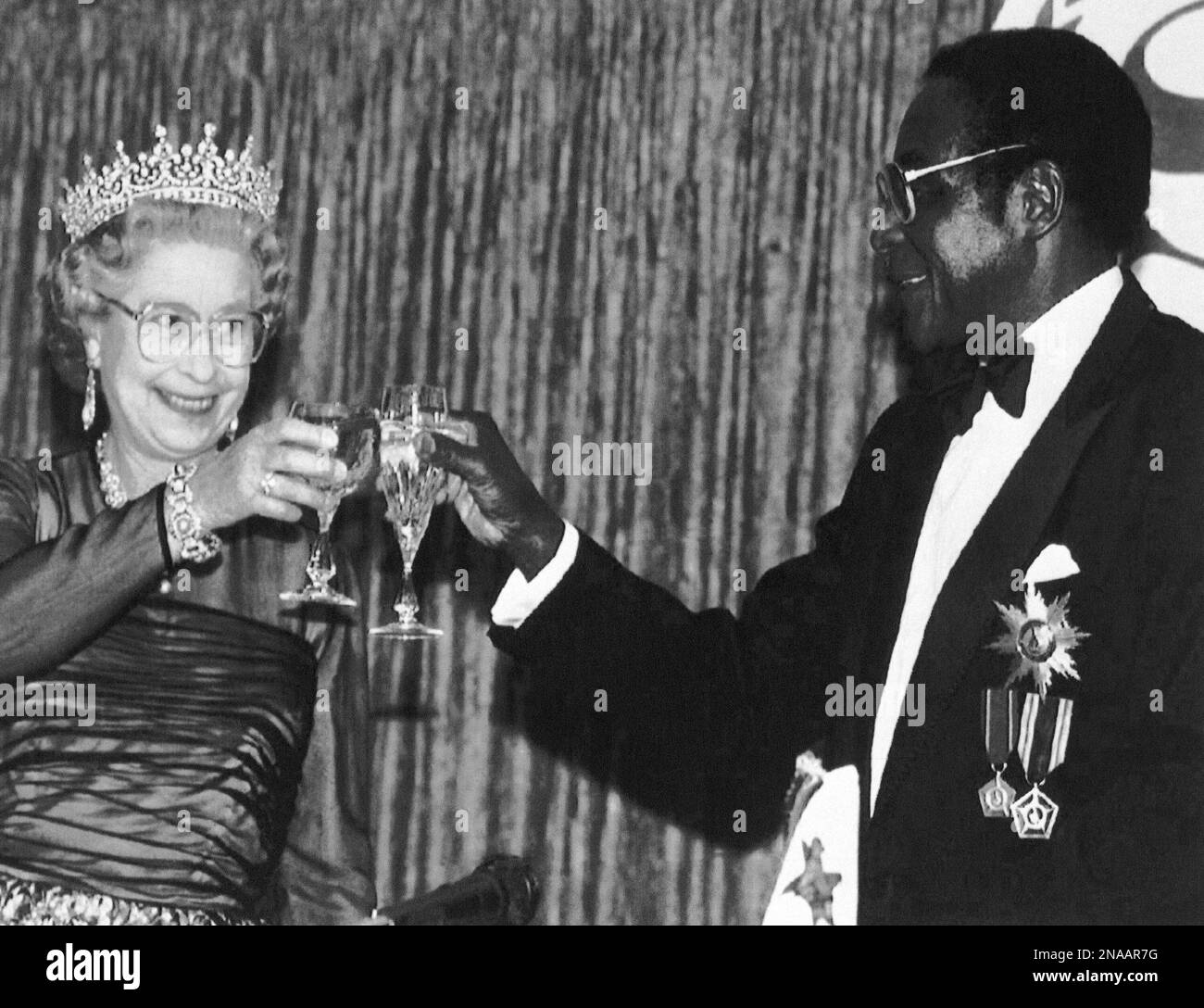 Britain's Queen Elizabeth II joins in a toast with President Robert ...