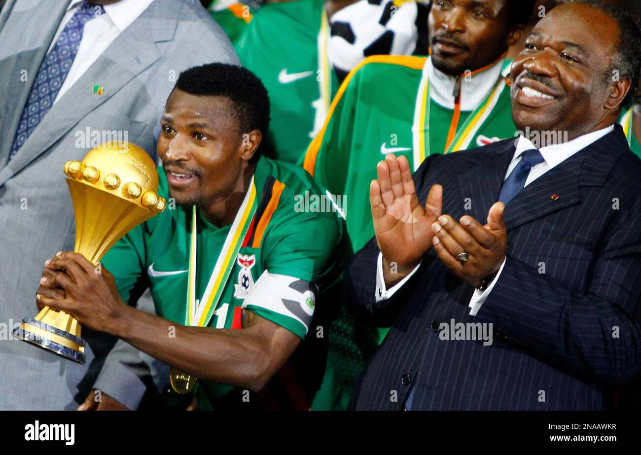 Zambia's captain Christopher Katongo, left, holds the trophy of the ...