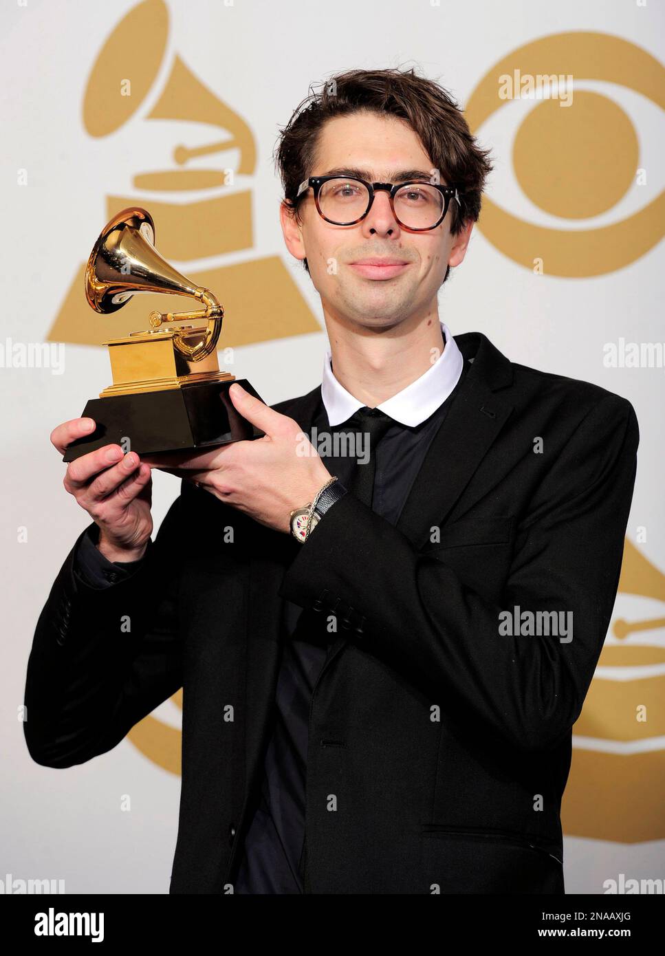 Sam Okell poses backstage with the award for best historical album for ...