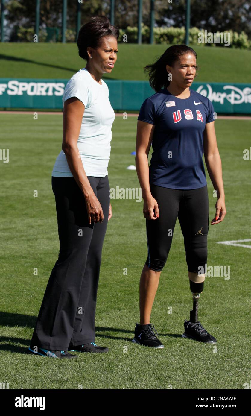 First lady Michelle Obama talks with paralympian April Holmes as she ...