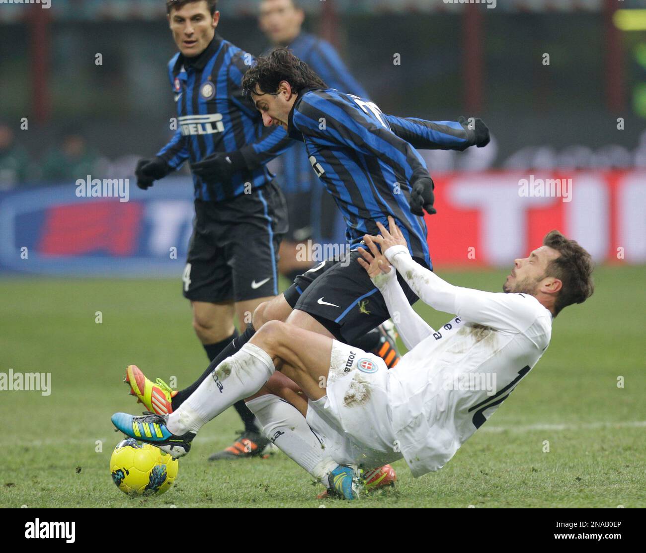 Inter Milan Argentine forward Diego Milito, left, is tackled by Novara ...