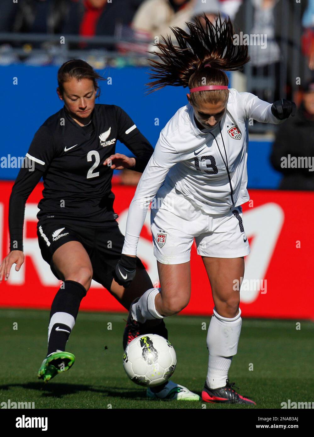 United States' Alex Morgan (13) and New Zealand's Ria Percival (2) play ...