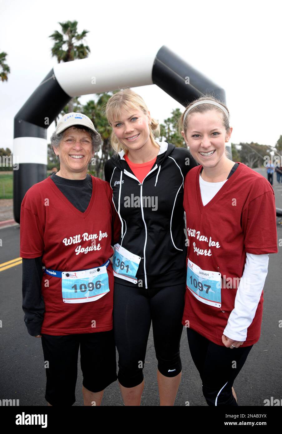 Celebrity host Alison Sweeney, center, poses with runners before her ...