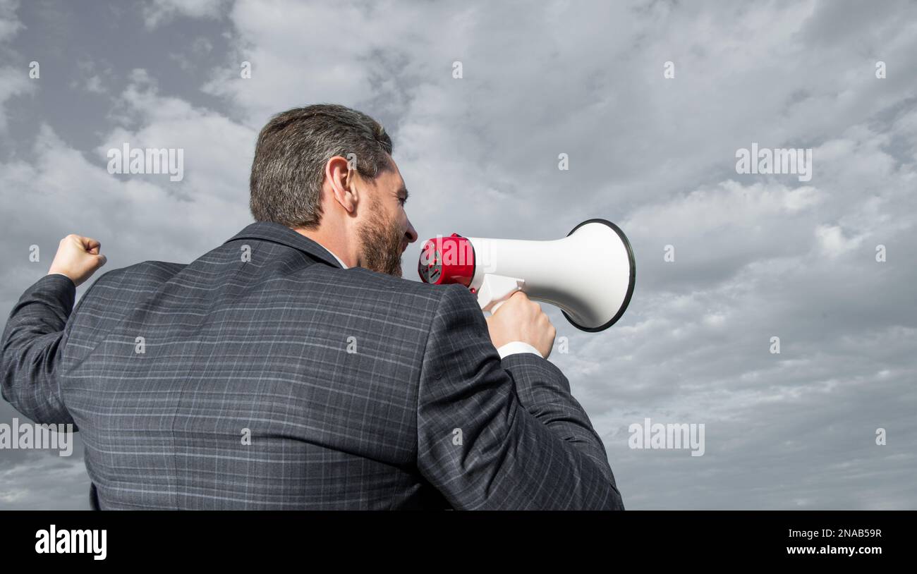 back view of businessman agitate in loudspeaker on sky background Stock ...