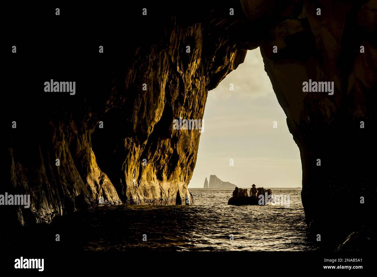 Zodiac in rocky arch, Kicker Rock, San Cristobal Island, Galapagos ...