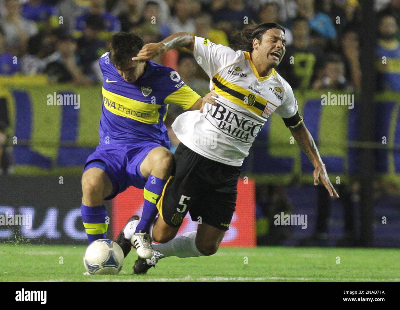 Boca Juniors' Pablo Mouche, left, battles for the ball with Ariel ...