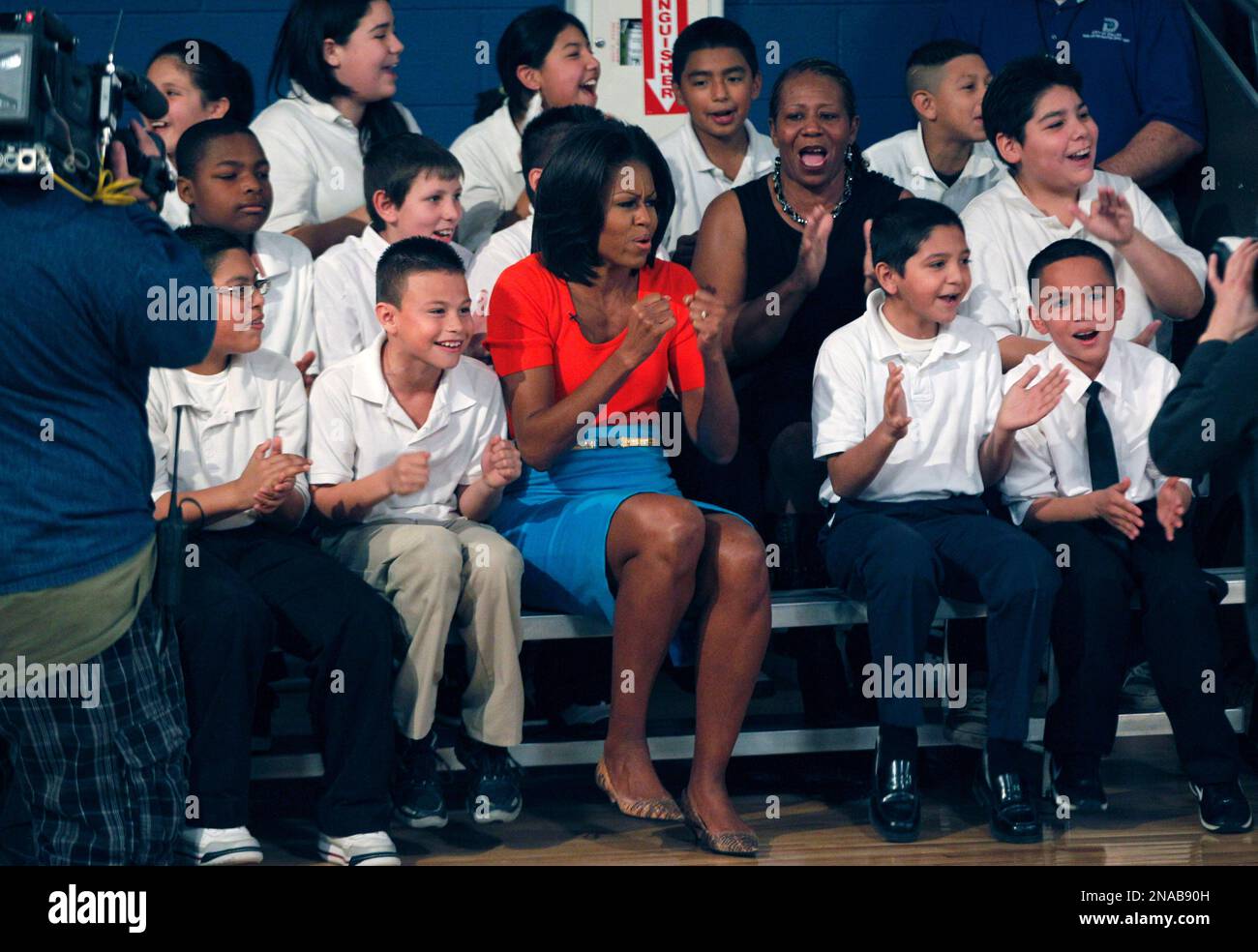 First Lady Michelle Obama cheers with school children during a cooking ...