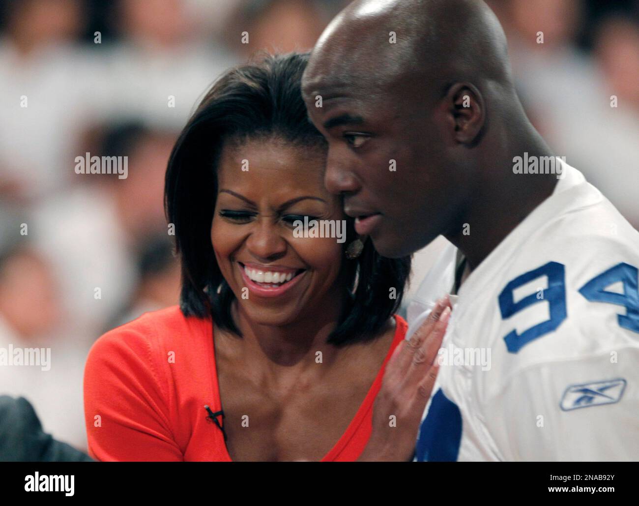 First Lady Michelle Obama laughs with Dallas Cowboys football player ...