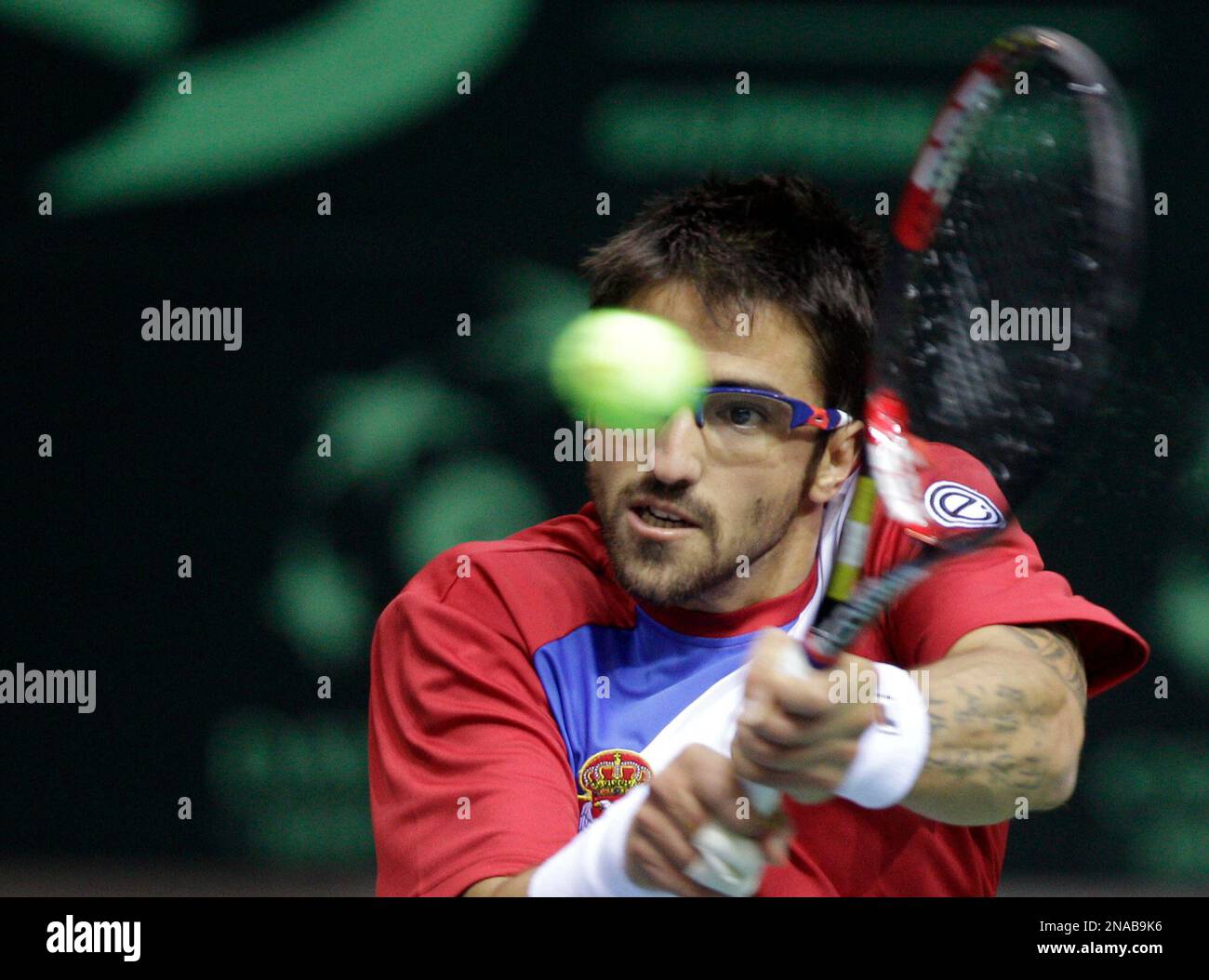 Janko Tipsarevic of Serbia returns a ball to Filip Prpic of Sweden ...