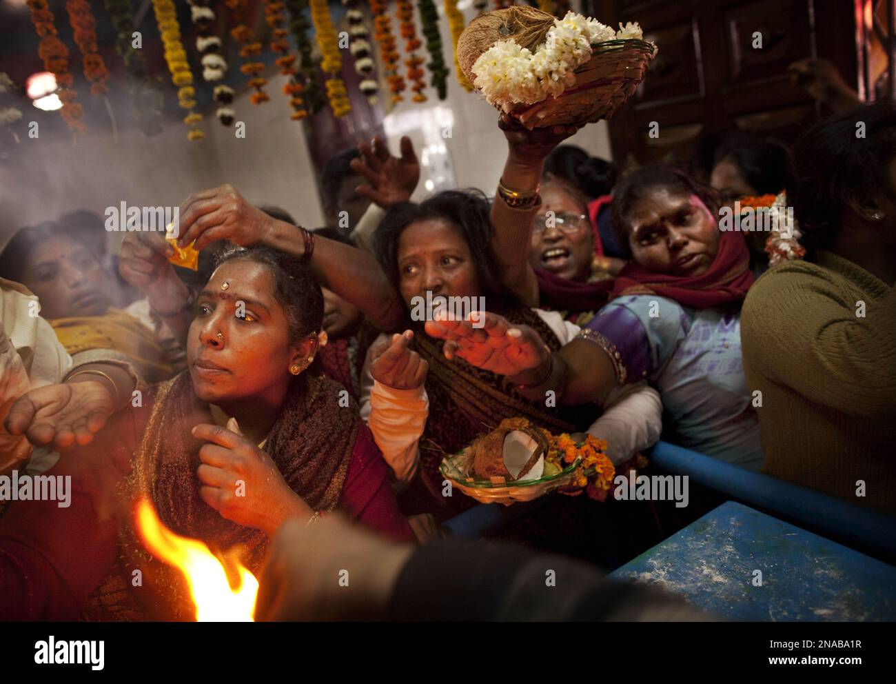 Tamil Hindu worshippers crowd as part of a blessing ritual for the ...