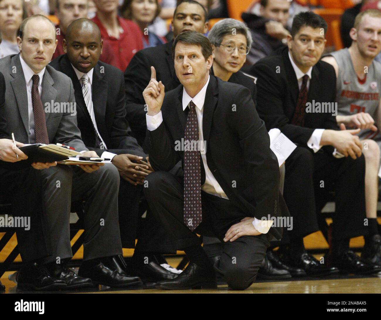 Washington State head coach Ken Bone, center, looks on in the first ...