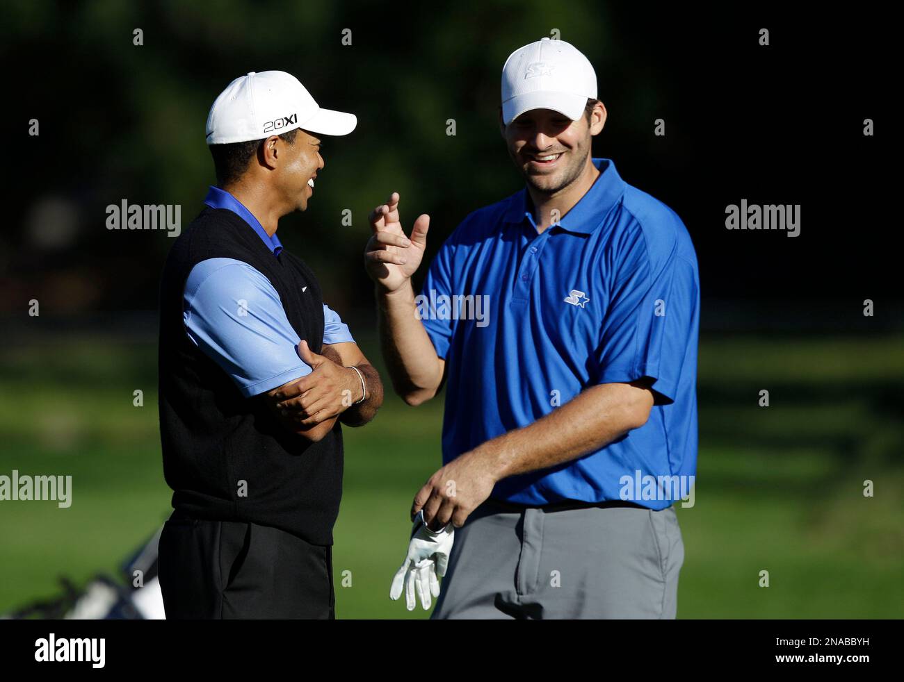 Tiger Woods, left, laughs with his amateur partner, Dallas Cowboys ...