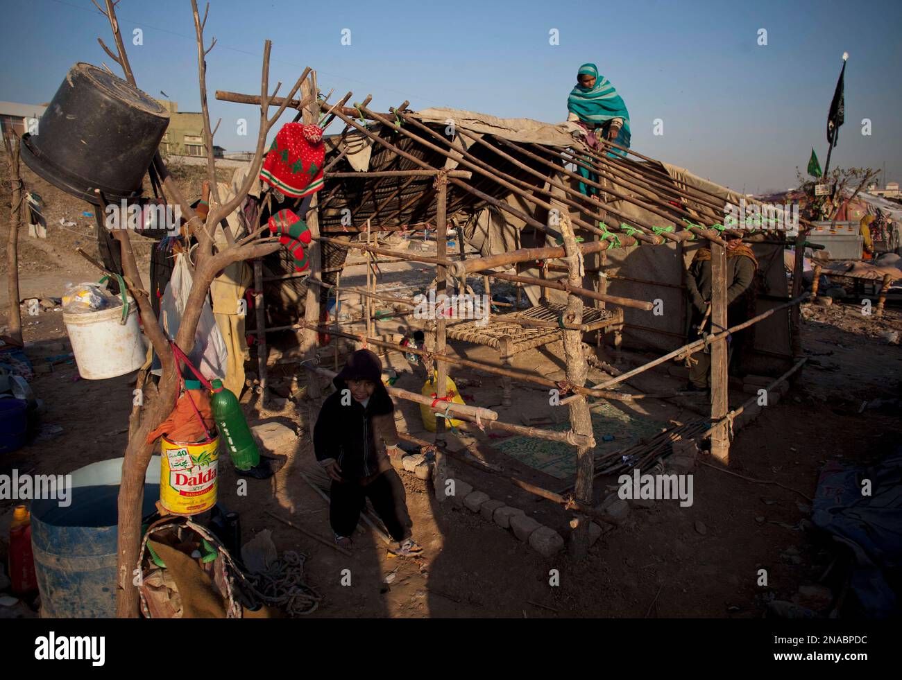 A Pakistani woman builds her home in slums of Rawalpindi city in ...
