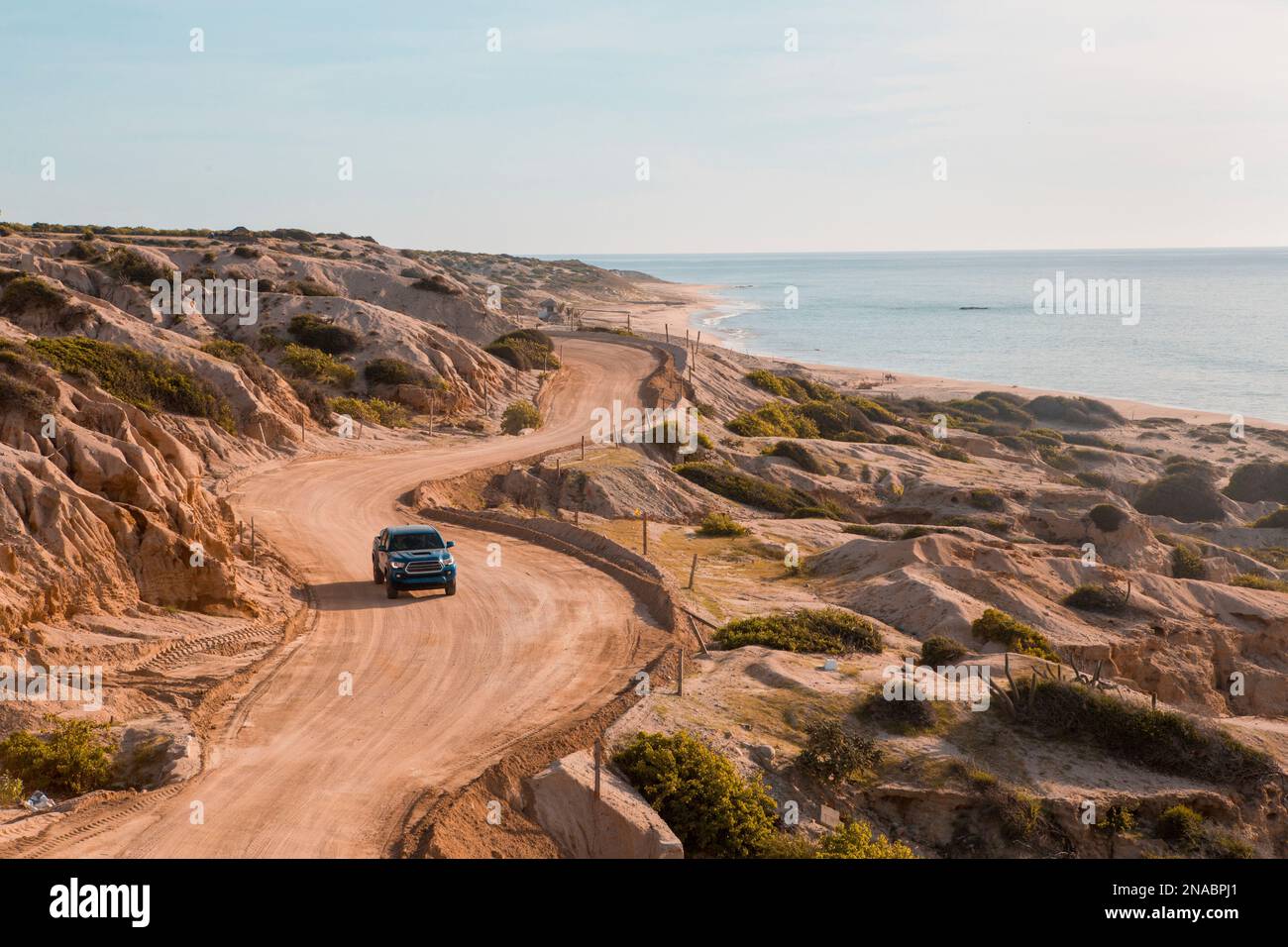 Truck drives the East cape of the Baja Peninsula; Cabo San Lucas, Baja ...
