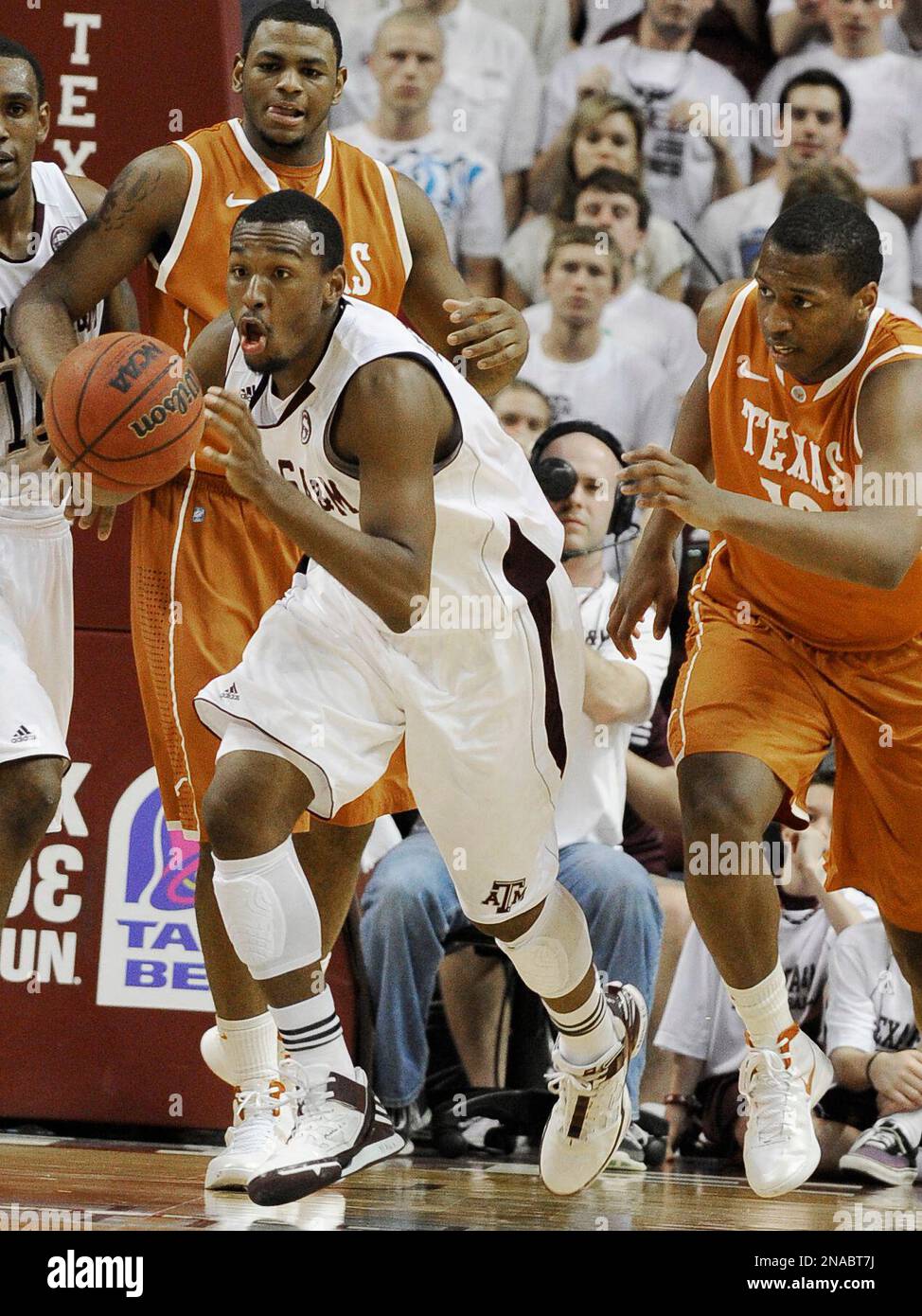 Texas A&M's Elston Turner, center, takes control of the ball as Texas ...