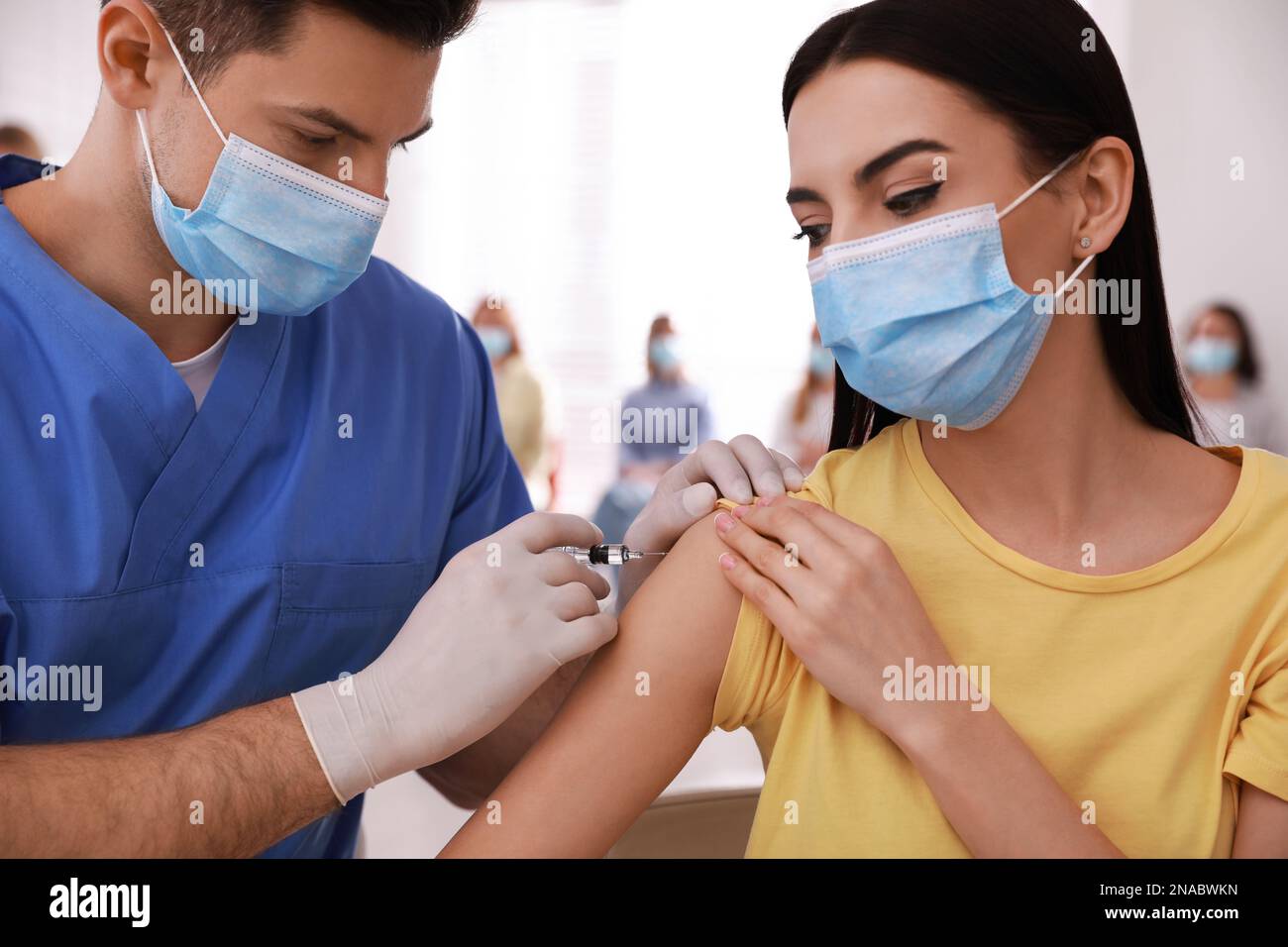 Doctor giving injection to patient in hospital. Vaccination campaign ...