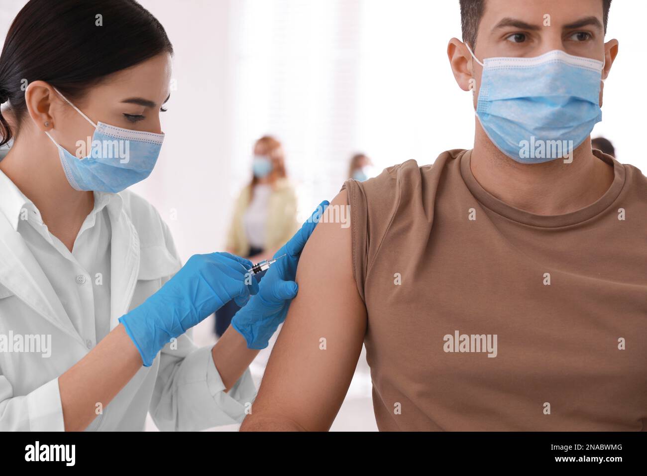 Doctor giving injection to patient in hospital. Vaccination campaign ...