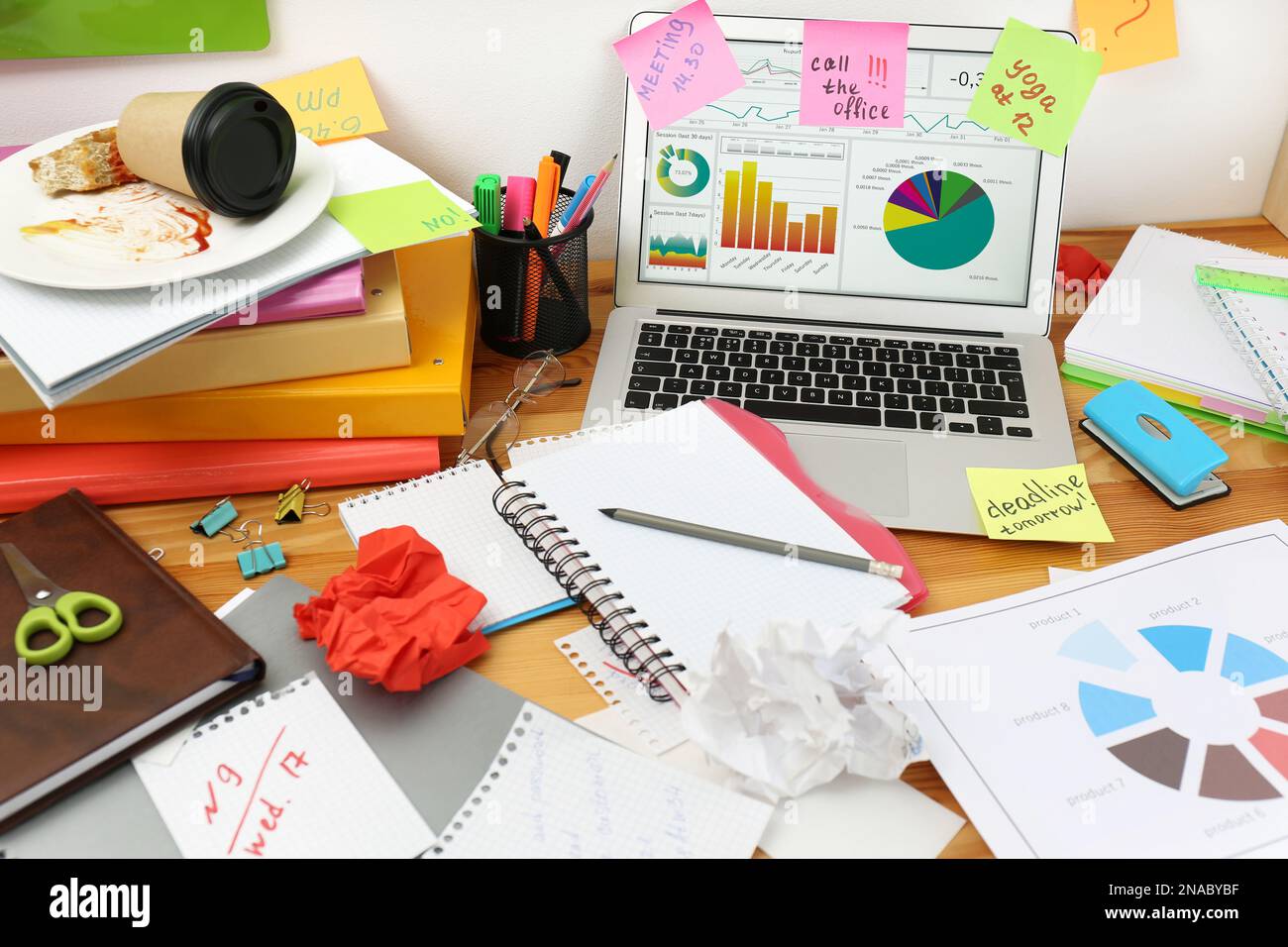 Messy table with laptop and stationery. Concept of being overwhelmed by ...