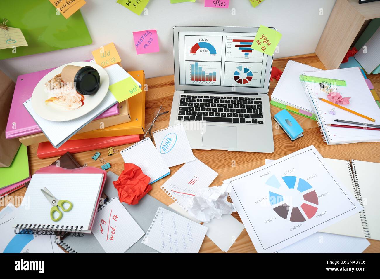Messy table with laptop and stationery. Concept of being overwhelmed by ...
