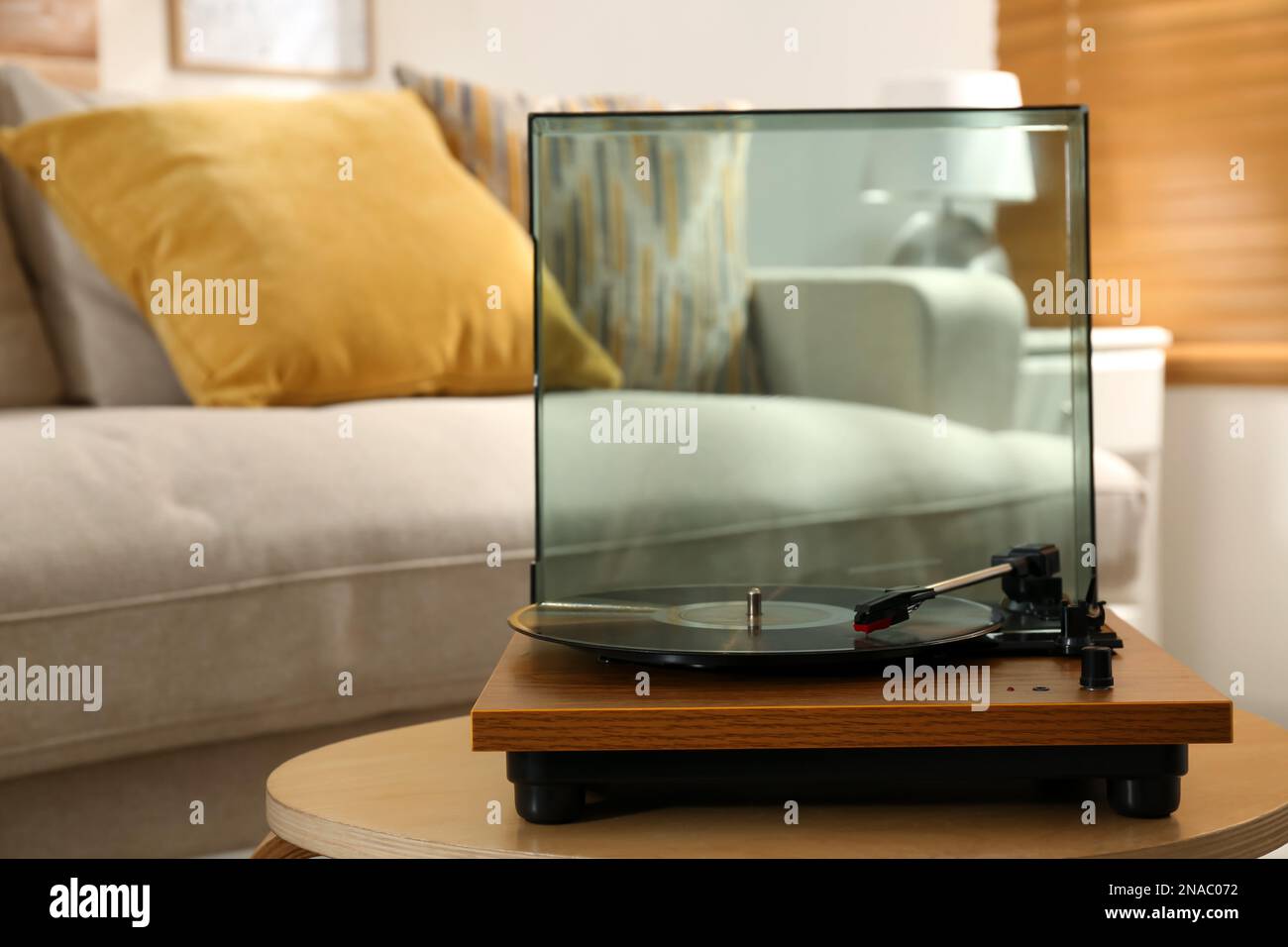 Modern vinyl record player with disc on table indoors Stock Photo - Alamy