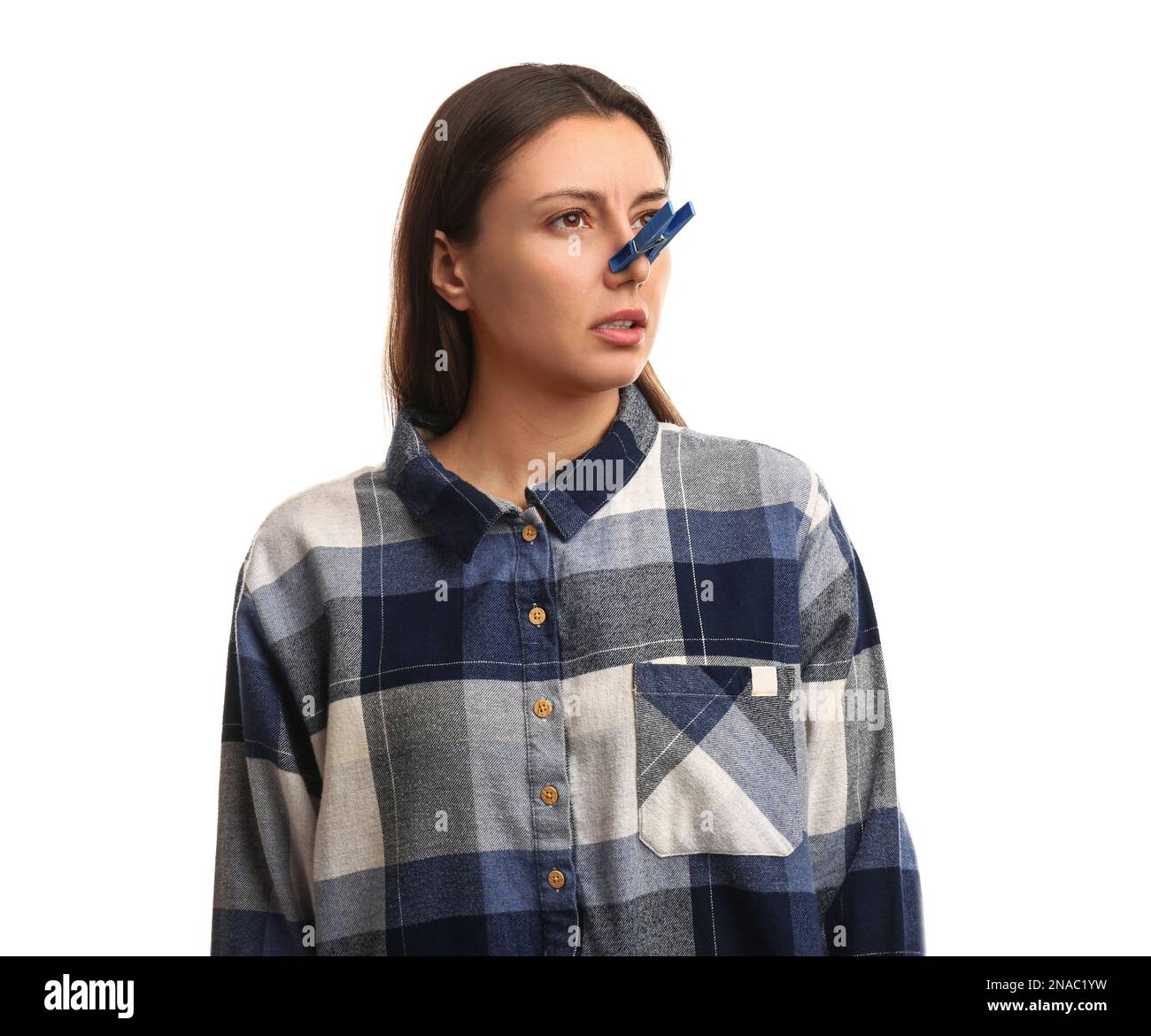 Young woman with clothespin on white background. Runny nose concept ...