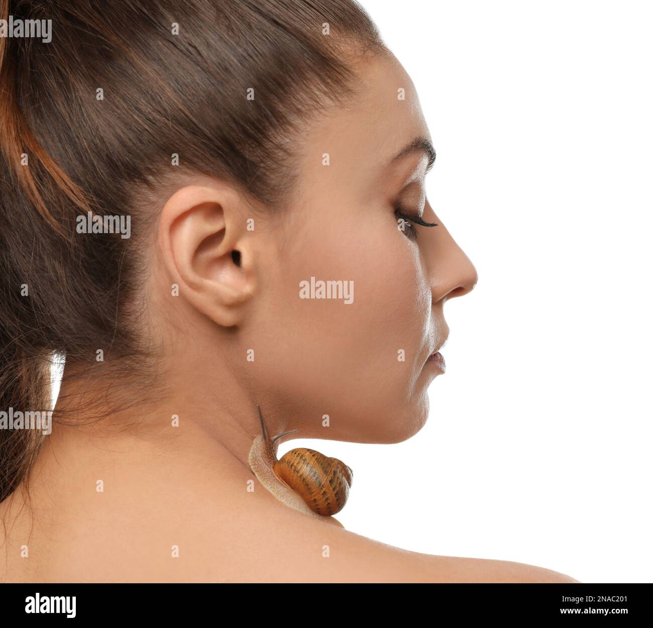 Beautiful young woman with snail on her neck against white background ...