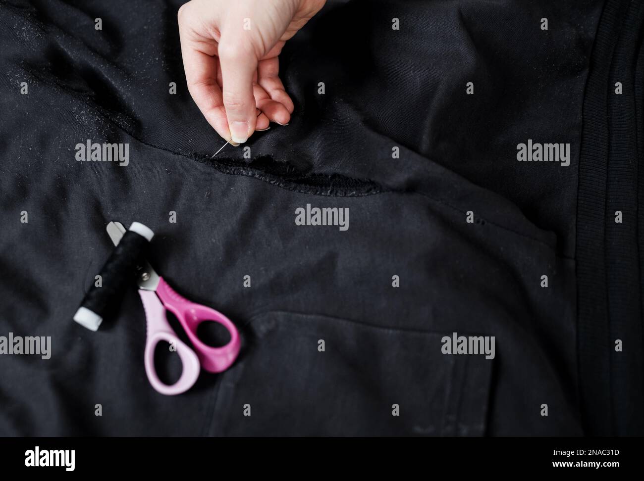 Mending clothes. Old worn clothes. Repair concept, selective focus ...