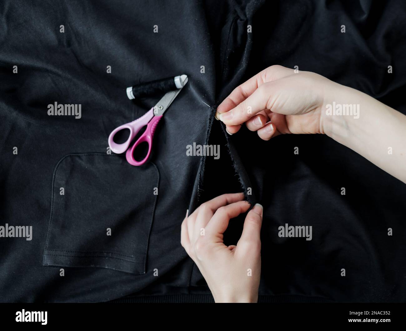 the process of sewing with a needle thread. restoration of old worn-out ...