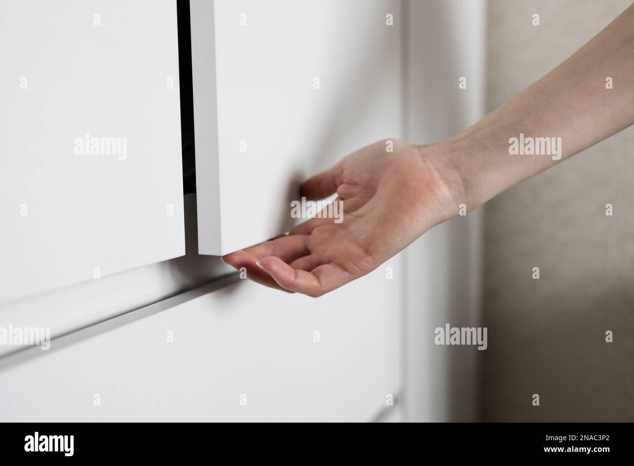 Woman hand pulling a drawer of white storage. open drawer wooden in ...