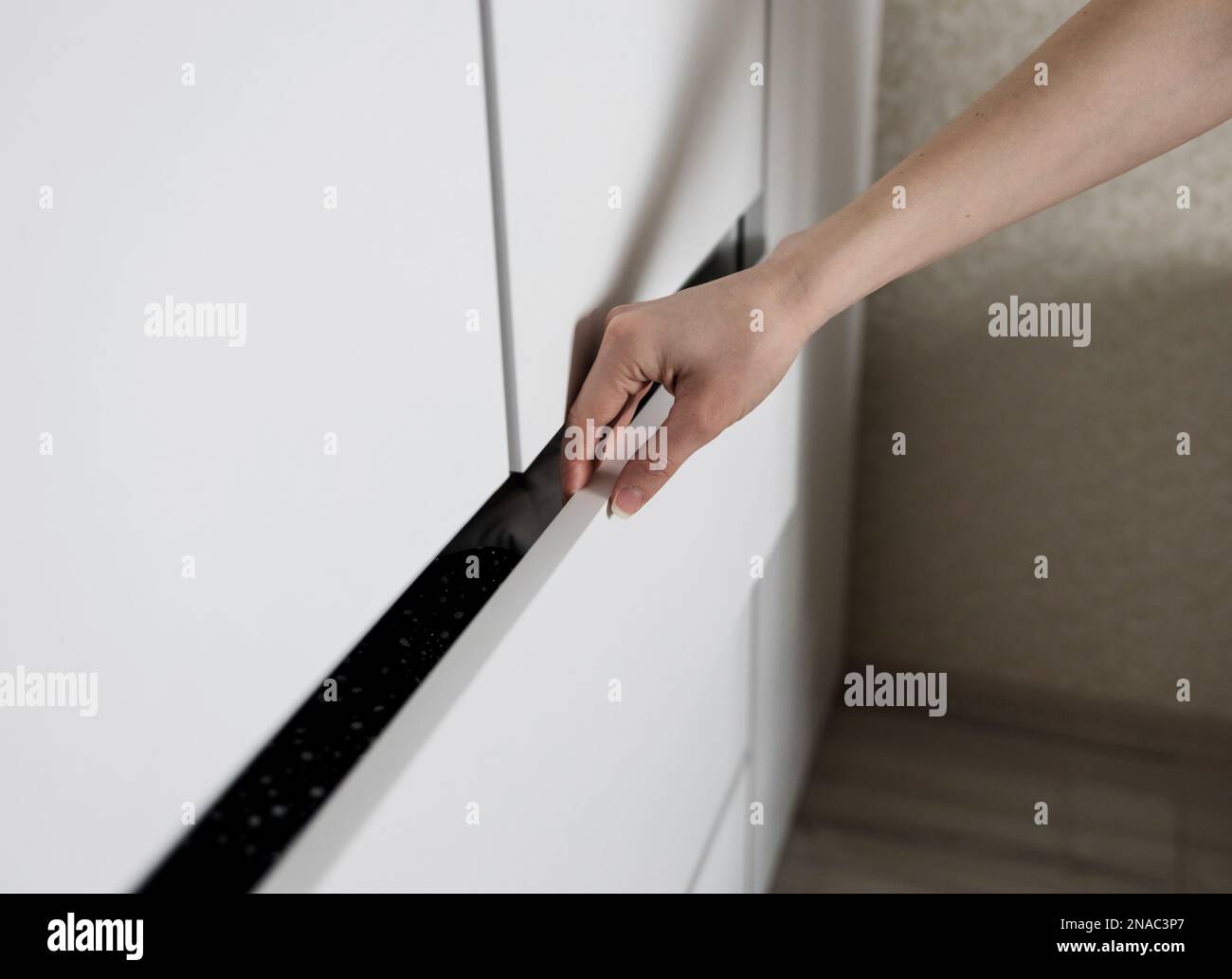 Woman open shelf, pull open drawer wooden in cabinet with clothes Stock ...