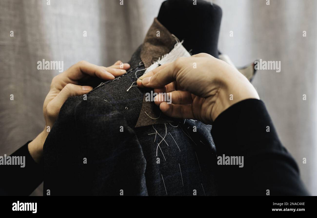 male tailor works in a costume workshop. tailoring and repair of ...