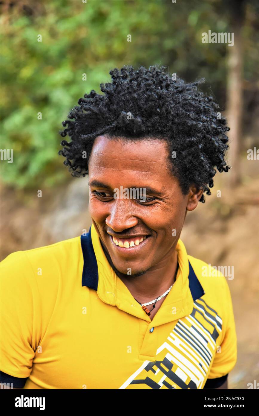 Portrait of a young man with a big smile in rural Ethiopia; Ethiopia ...