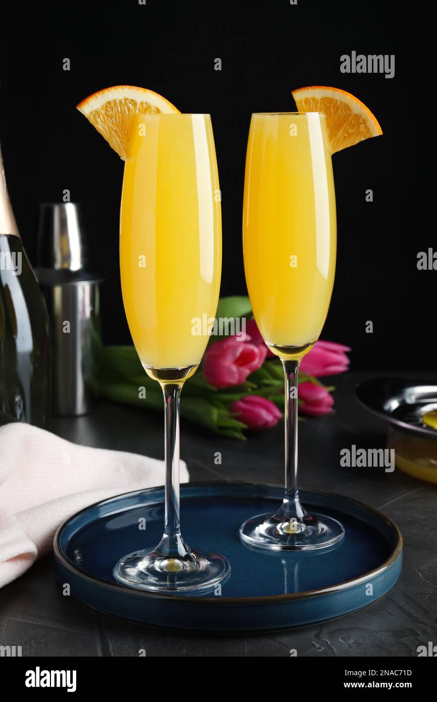 Glasses of Mimosa cocktail with garnish on grey table Stock Photo - Alamy