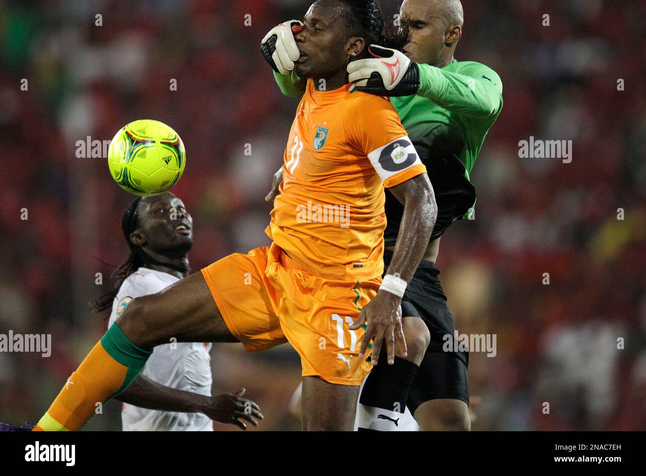 Ivory Coast's captain Didier Drogba, center, clashes with Equatorial ...