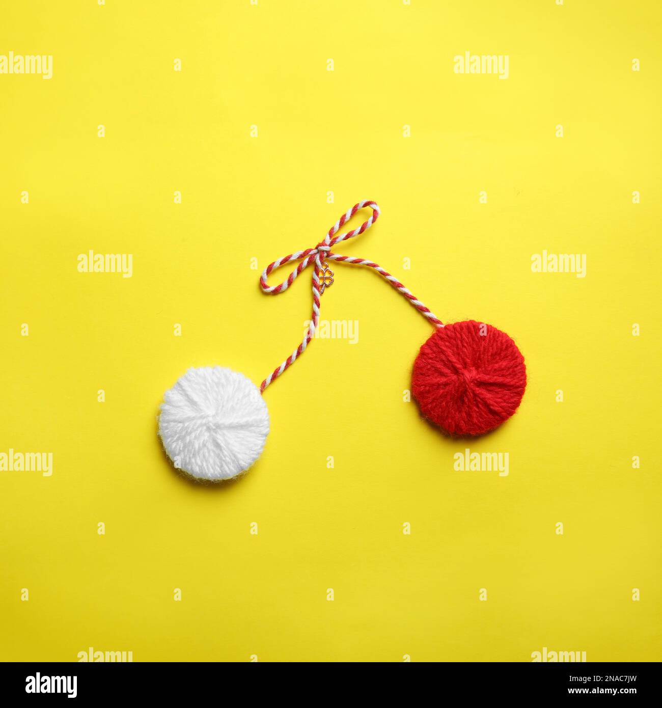 Traditional martisor on yellow background, top view. Beginning of ...