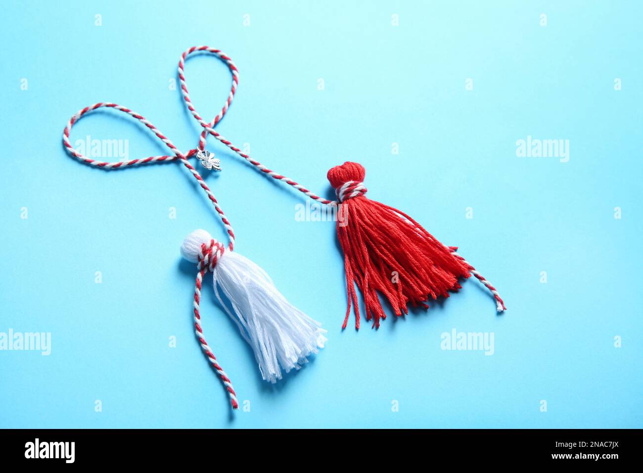Traditional martisor on light blue background. Beginning of spring ...