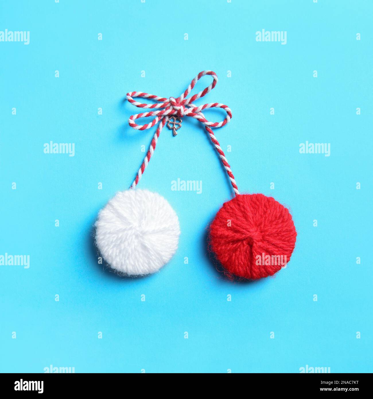 Traditional martisor on light blue background, top view. Beginning of ...