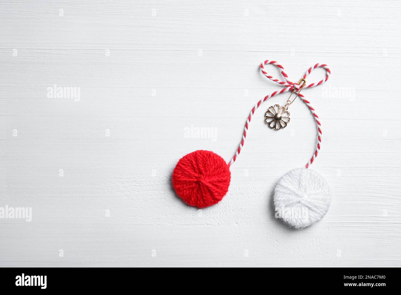 Traditional martisor on white wooden background, top view with space ...
