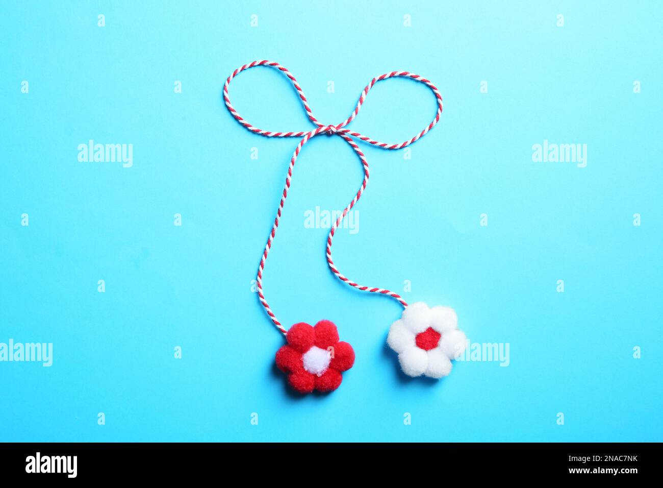 Traditional martisor with flowers on light blue background, top view ...