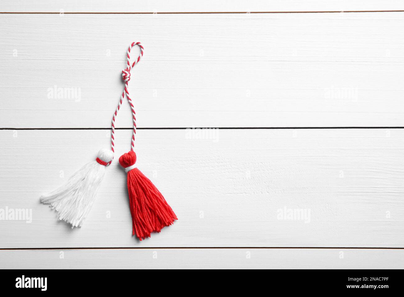 Traditional martisor on white wooden background, top view with space ...