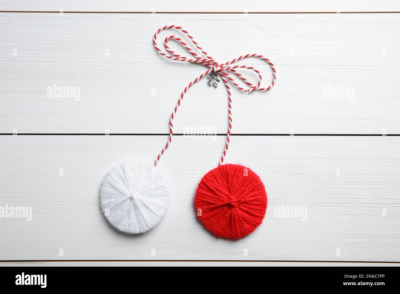 Traditional martisor on white wooden background, top view. Beginning of ...