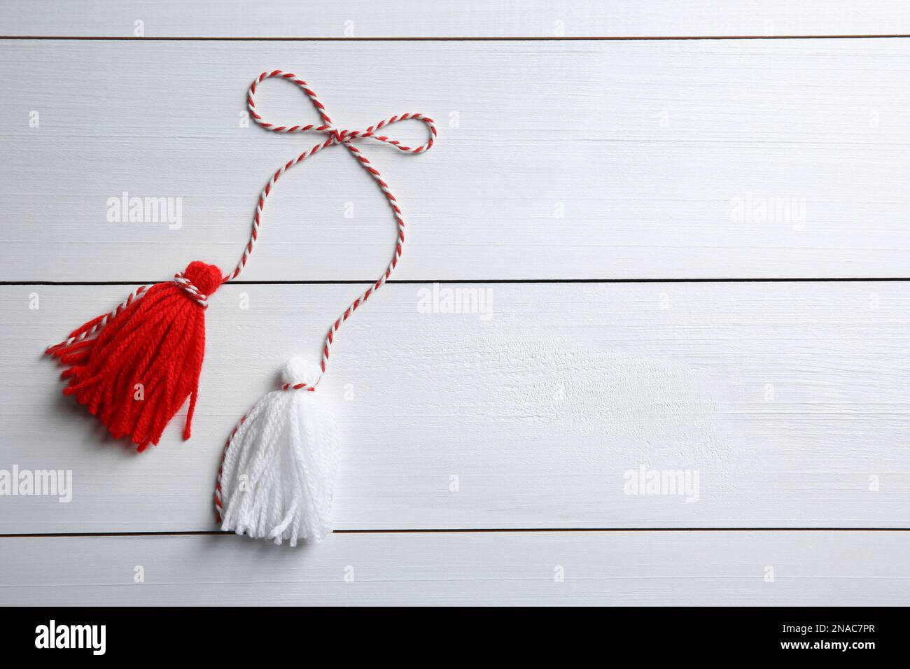 Traditional martisor on white wooden background, top view with space ...