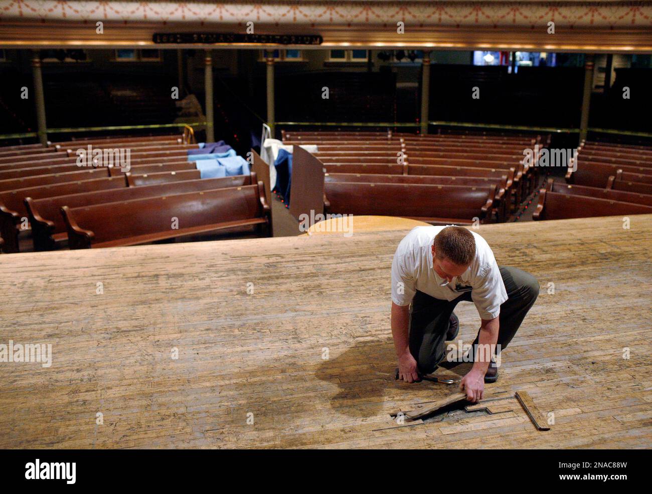 Jay McClellan removes a piece of the floor of the stage at The Ryman ...