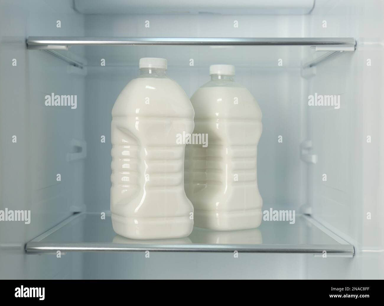 Gallons of fresh milk in refrigerator, closeup Stock Photo - Alamy
