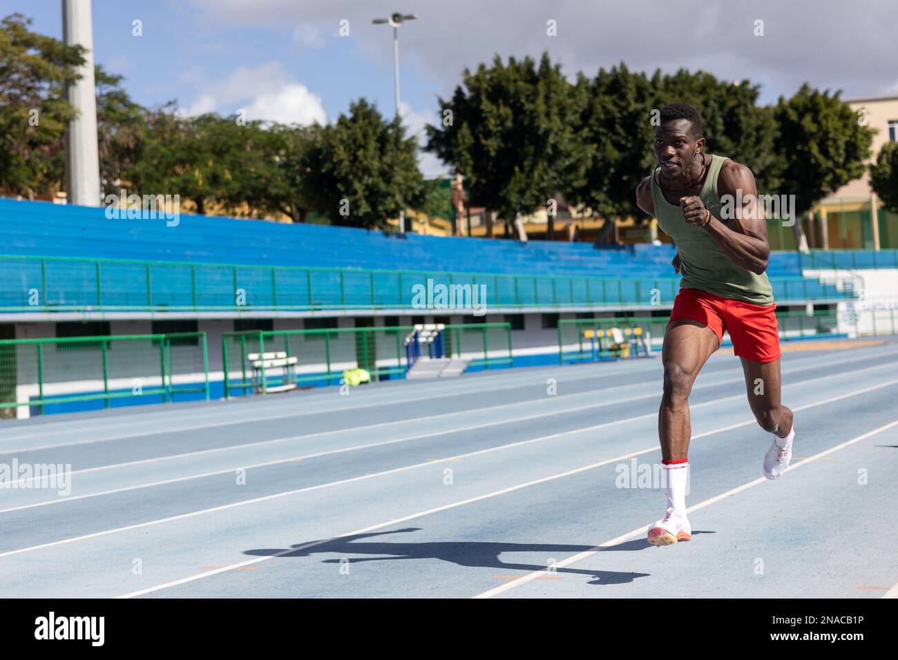 african man running on athletics track Stock Photo - Alamy