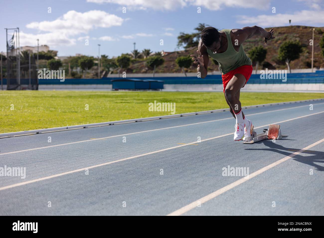 African runner starting a race on an athletics track Stock Photo - Alamy