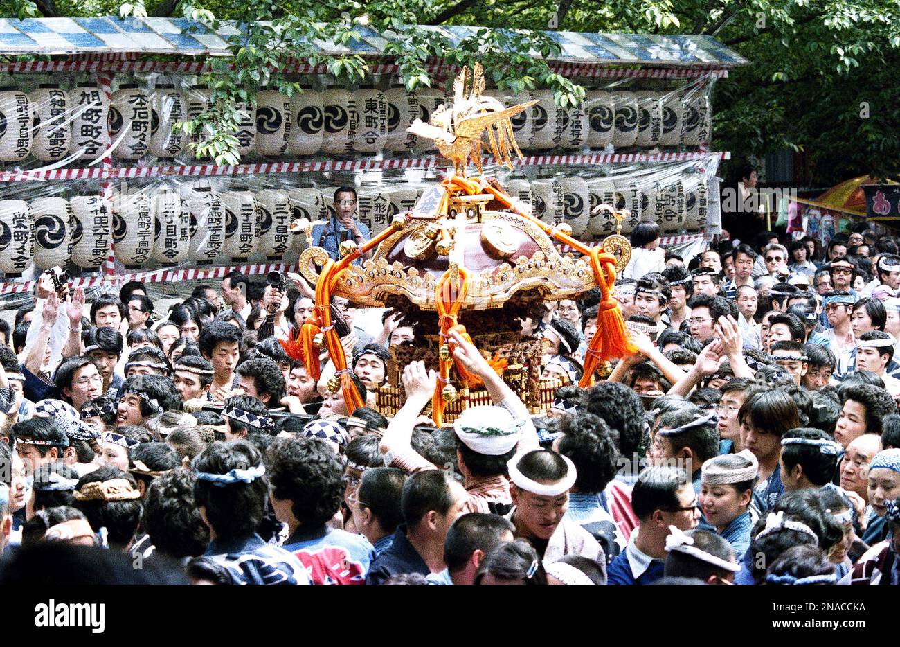 With an animated shout Tokyo residents in Happi Coats carry a Mikoshi ...