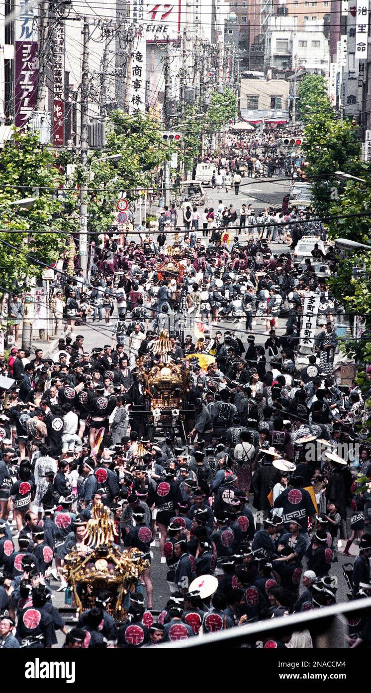 With an animated shout Tokyo residents in Happi Coats carry a Mikoshi ...