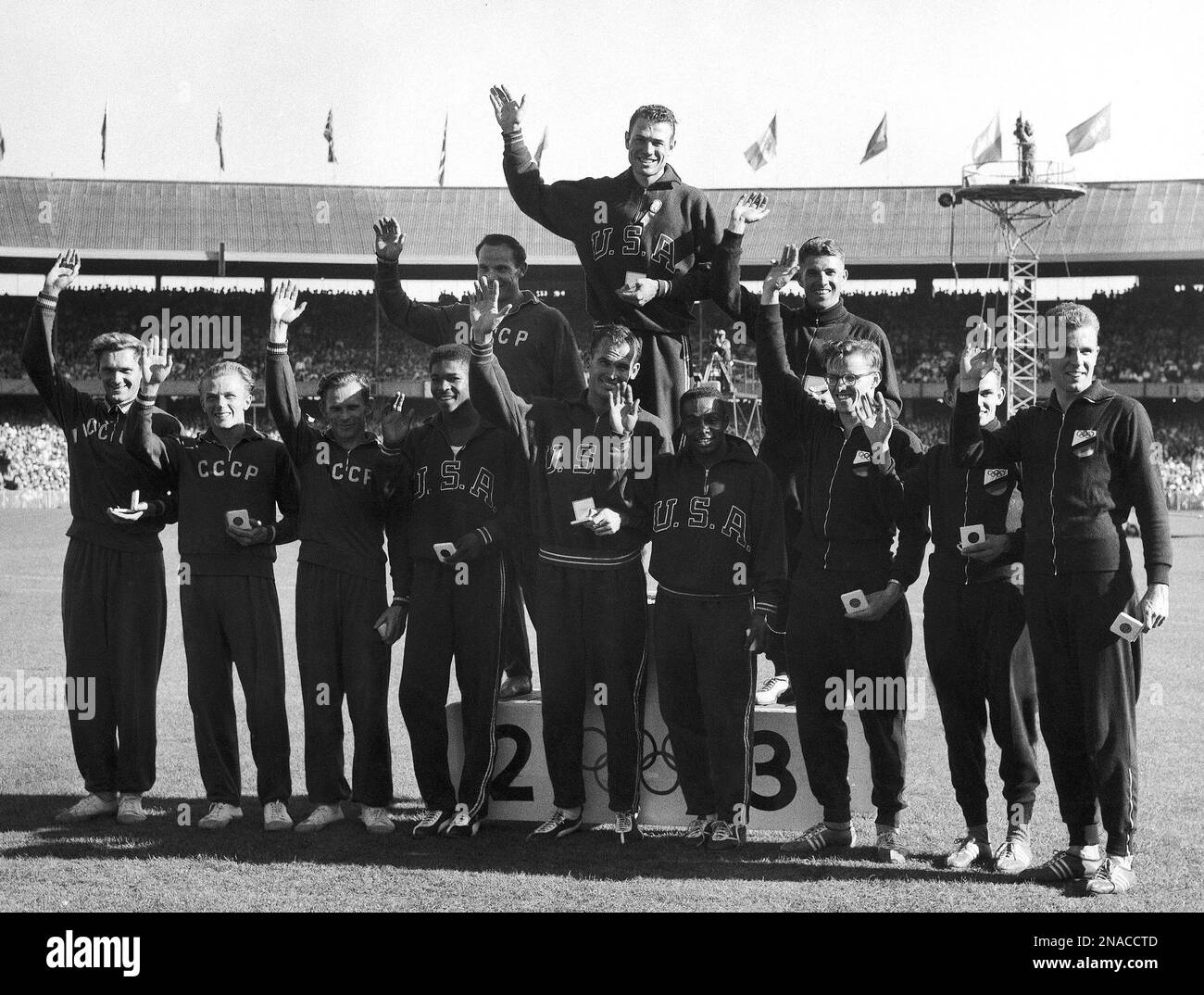 The victors wave from the podium after receiving their medals following ...